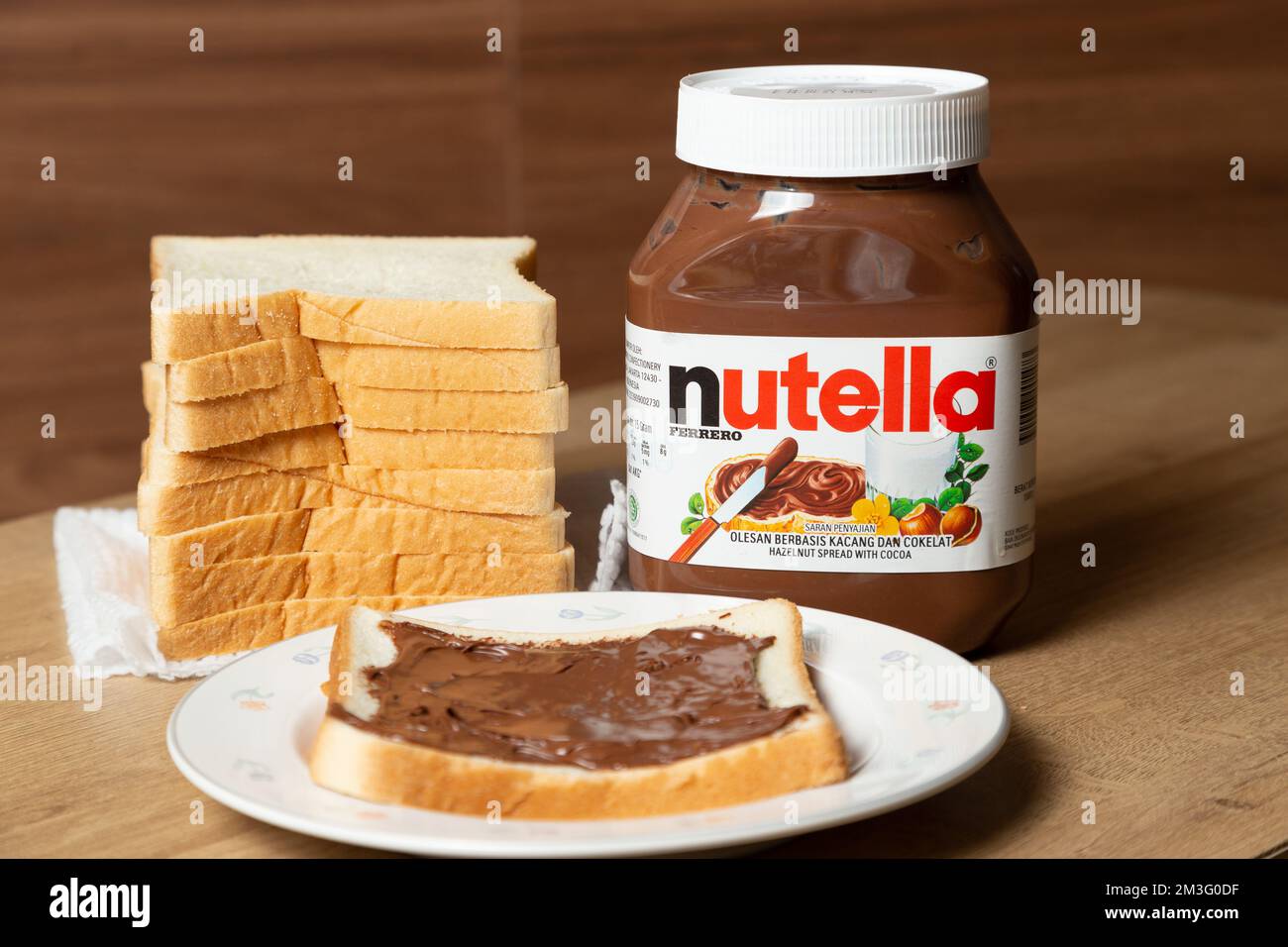 Nutella with large and small bottles and some white bread neatly ...
