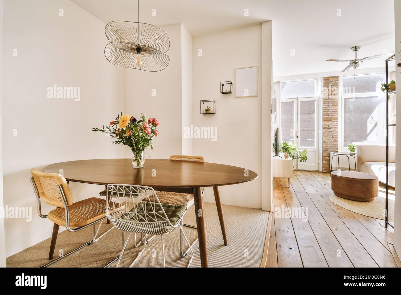 a dining table and chairs in a room with white walls, wood flooring and ...