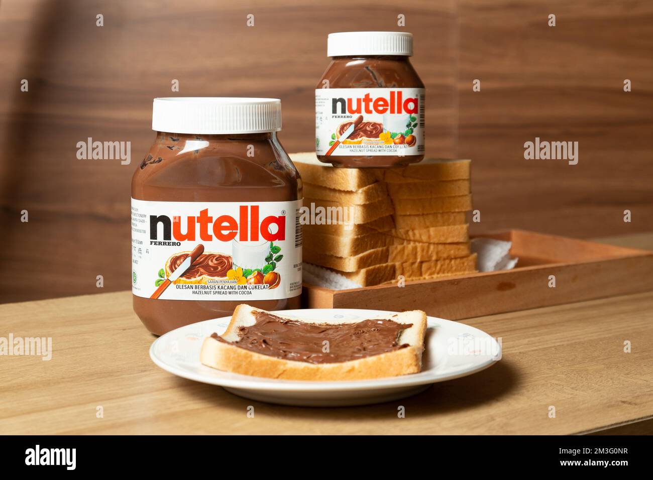 Nutella with large and small bottles and some white bread neatly ...