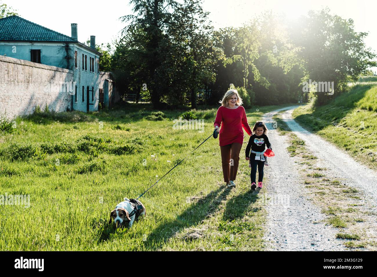 Trendy senior lady and her little toddler girl enjoying a walk in the ...