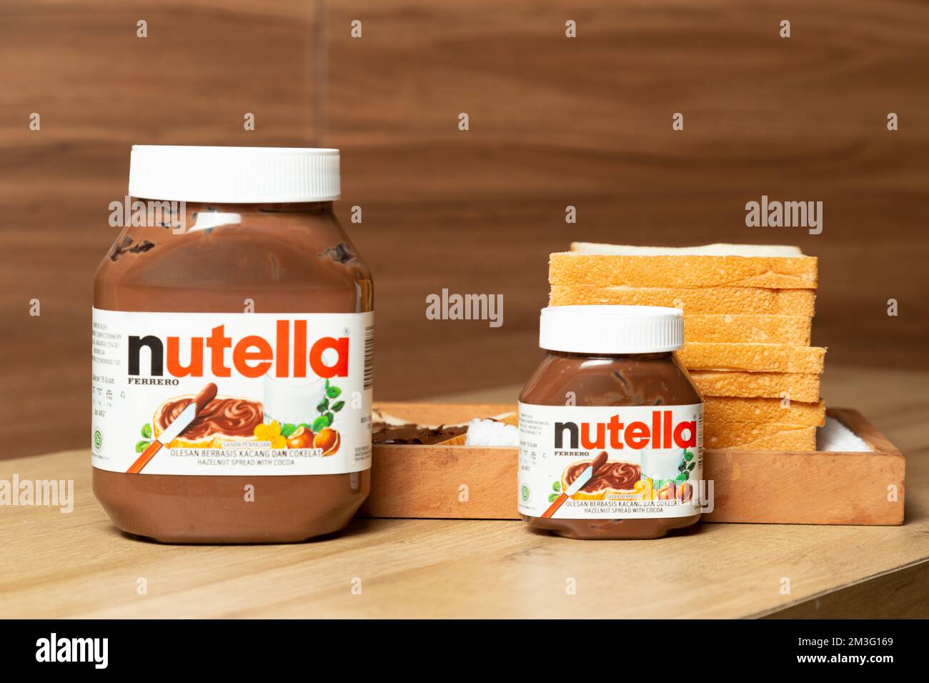 Nutella with large and small bottles and some white bread neatly ...