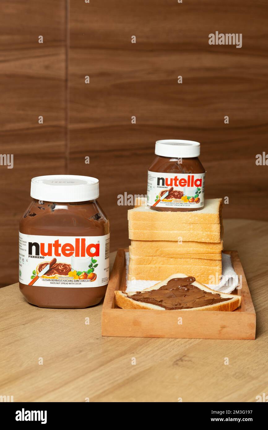 Nutella with large and small bottles and some white bread neatly ...