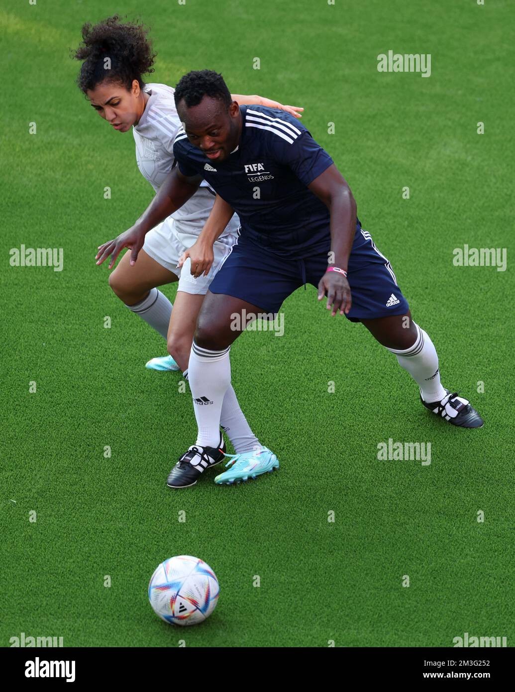Doha, Qatar. 15th Dec, 2022. Ghana's legend Michael Essien (R) competes ...