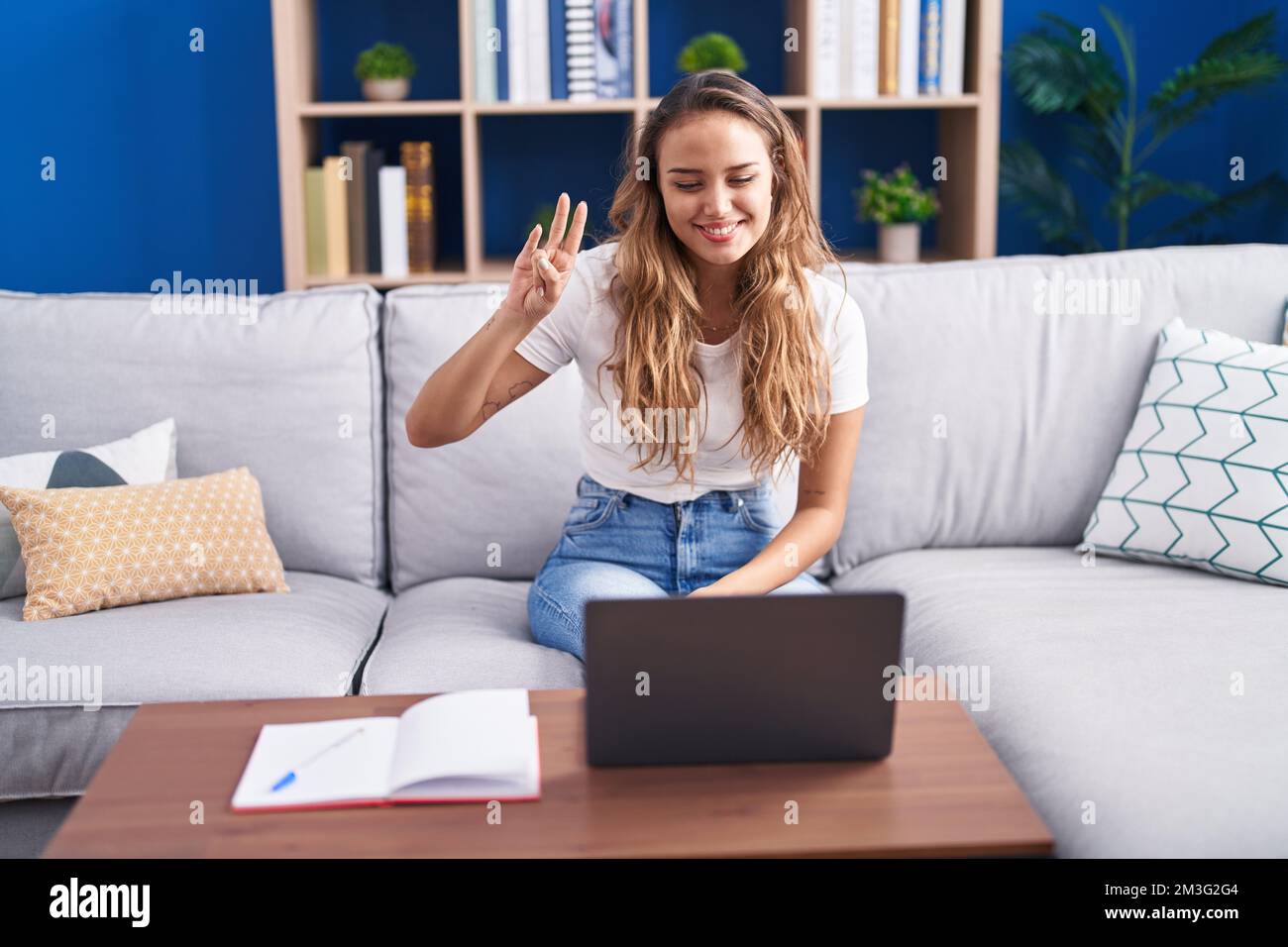 Young beautiful hispanic woman having video call communicate with sign ...