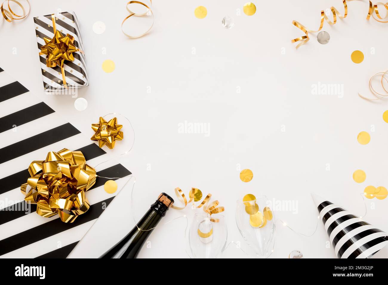 Christmas party composition. Gifts, hats, black and gold decorations on ...