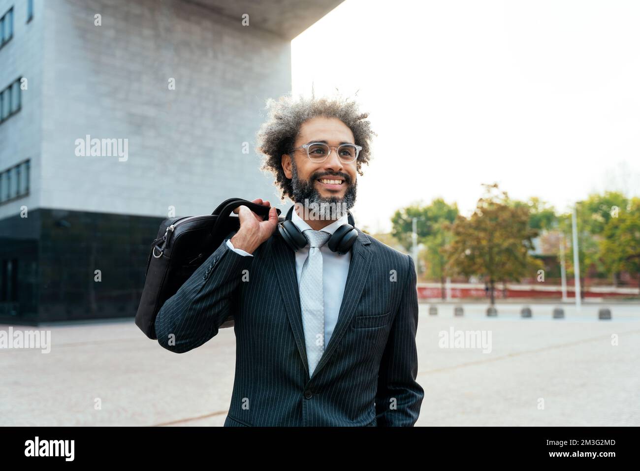 Young entrepreneur businessman walking outside his office after a long ...