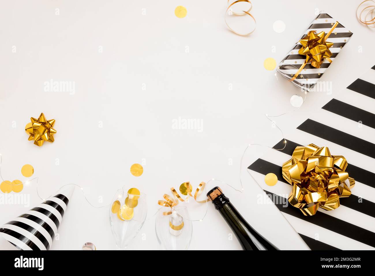 Christmas party composition. Gifts, hats, black and gold decorations on ...