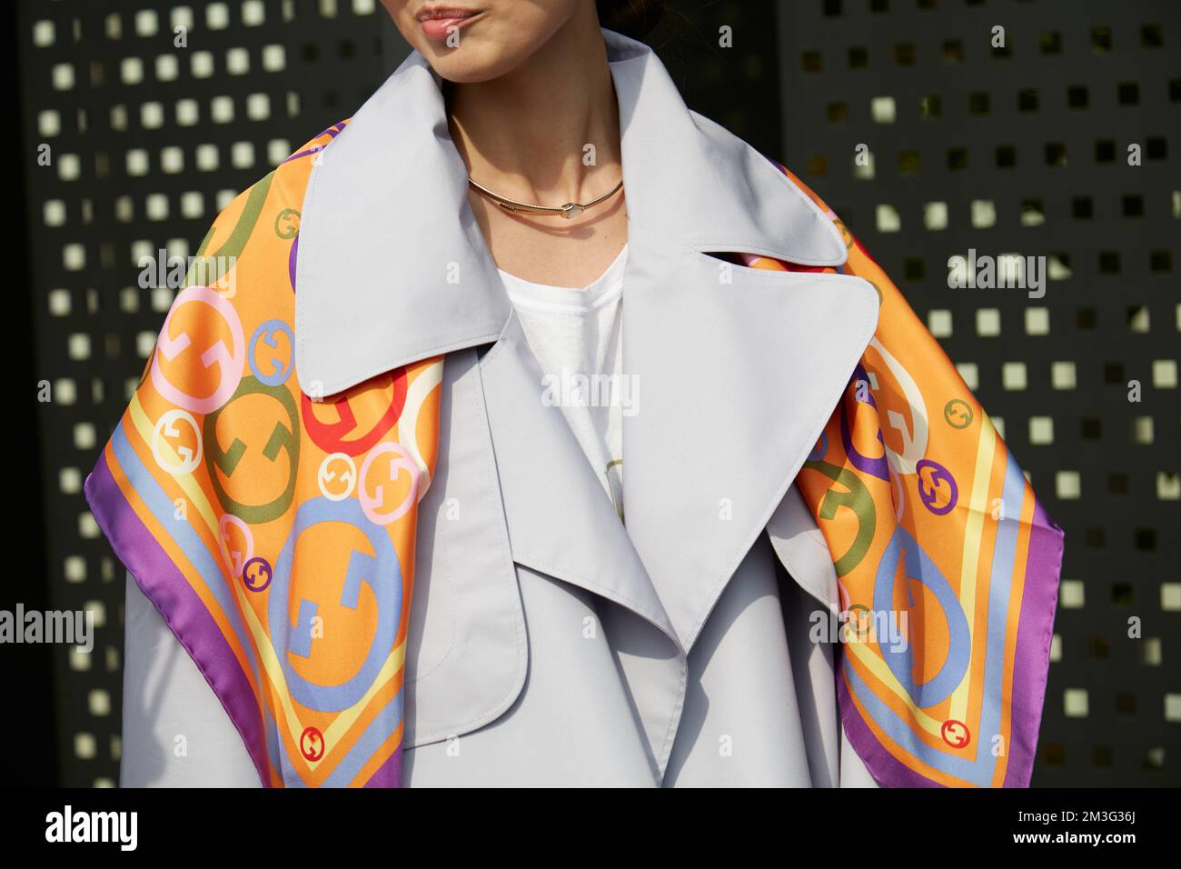 MILAN, ITALY - SEPTEMBER 23, 2022: Woman with gray trench coat and silk ...