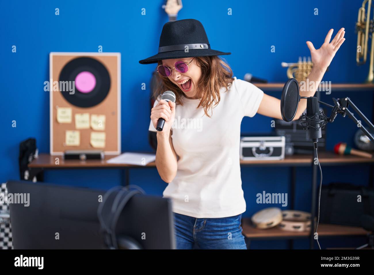 Young woman artist singing song at music studio Stock Photo - Alamy