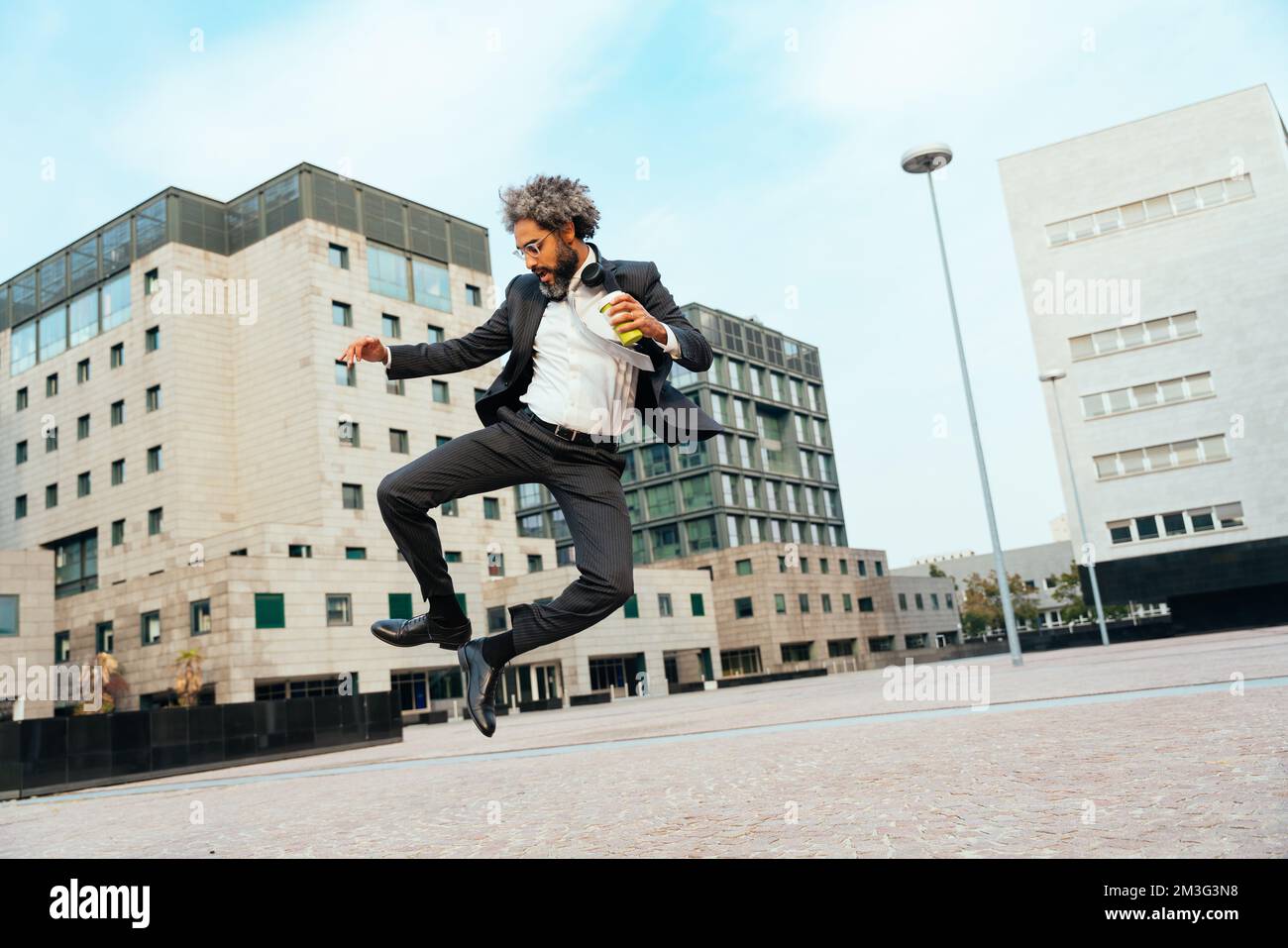 Young entrepreneur jumping and dancing to celebrate his successful day ...