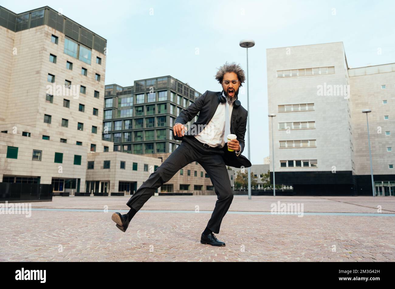 Young entrepreneur jumping and dancing to celebrate his successful day ...