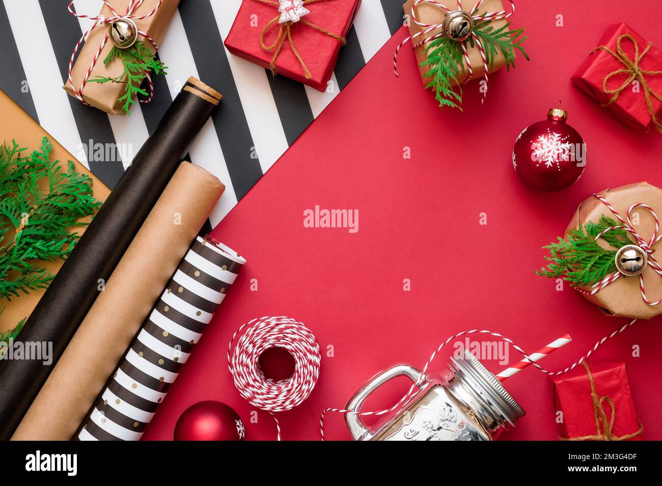 Christmas background with gift boxes, rope, paper's rools and ...