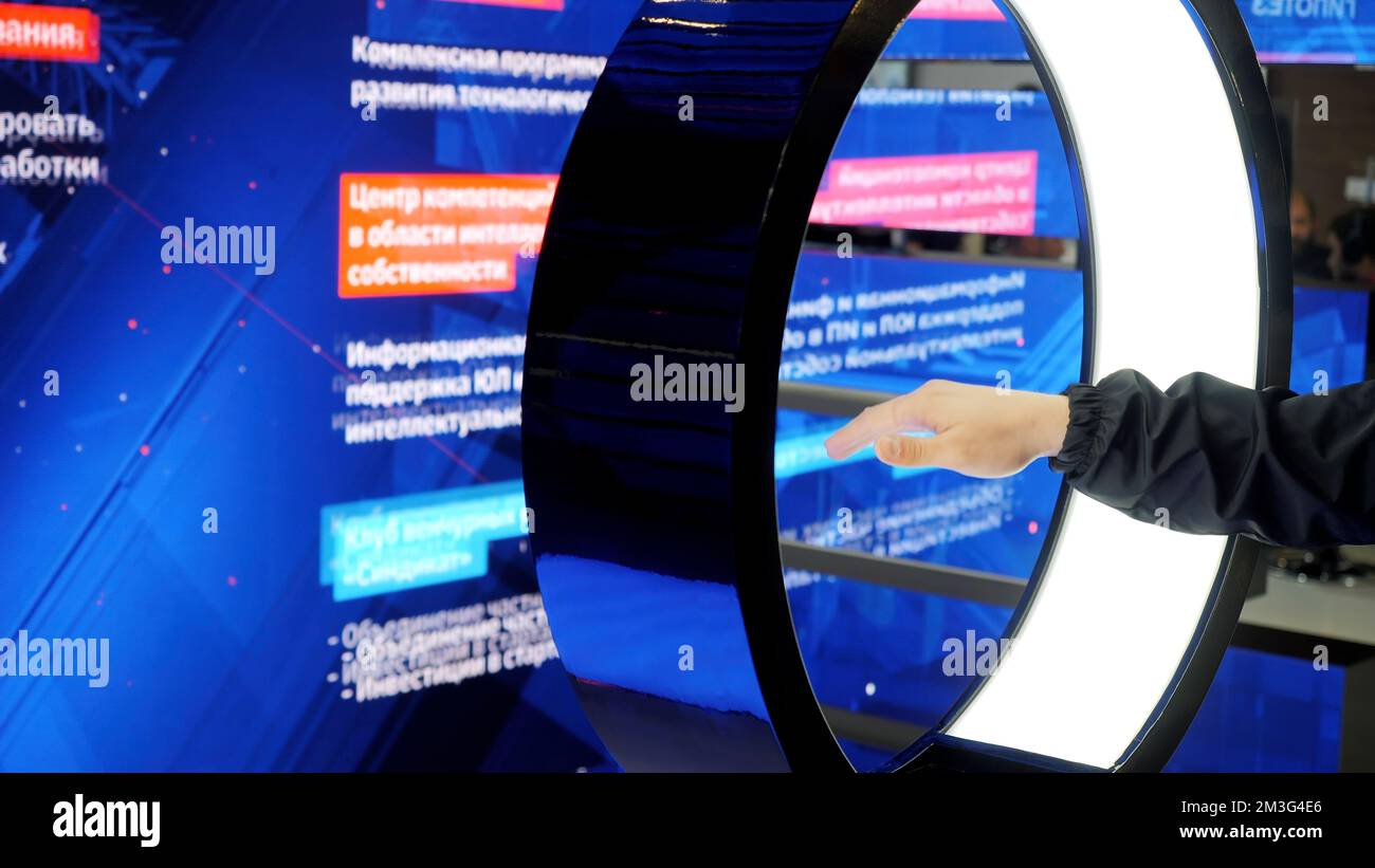 Close up of a male hand waving in front of a digital screen. Media ...