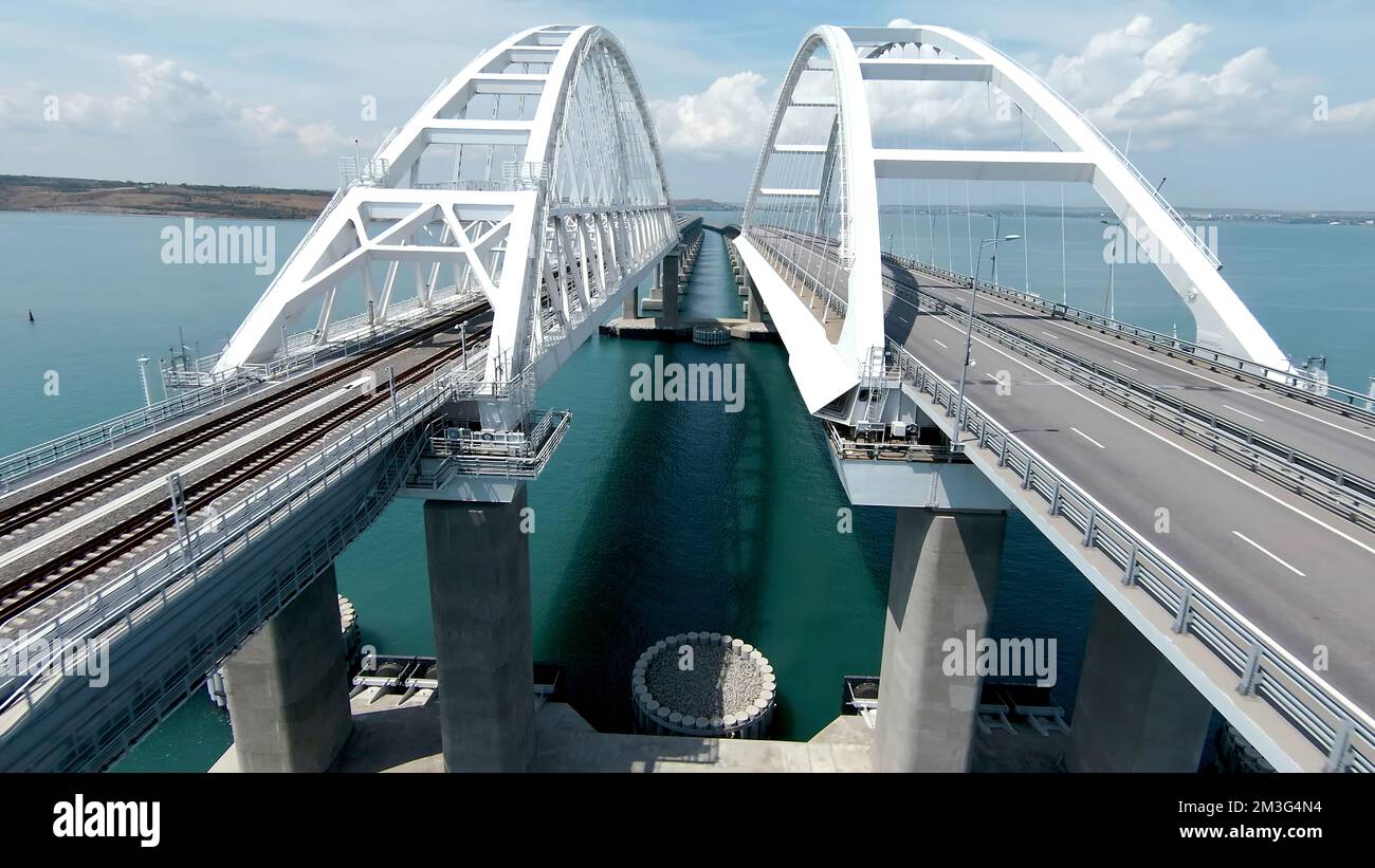 A large bridge with moving rare cars. Shot. Aerial view of a flight ...