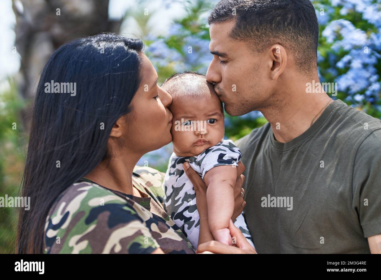 Hispanic family hugging each other and kissing at park Stock Photo - Alamy