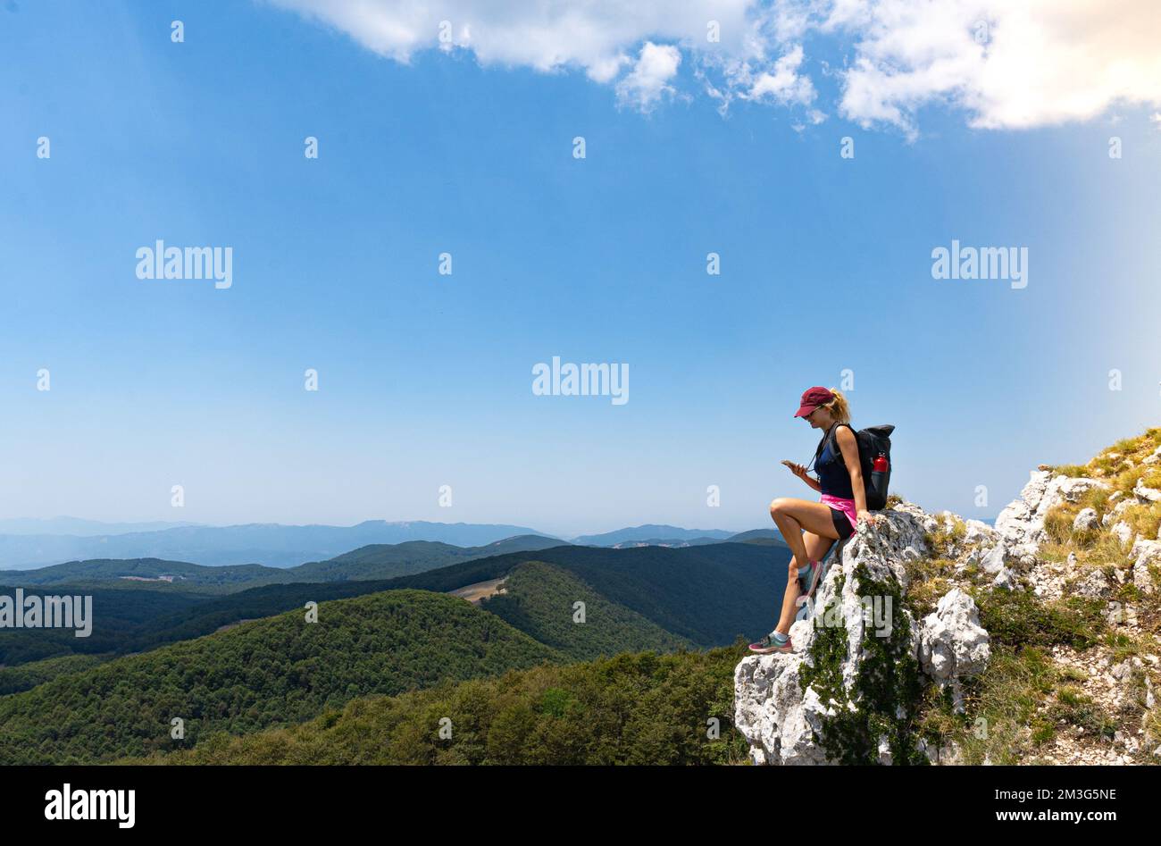 explorer woman sitting looking her smartphone with in background a ...
