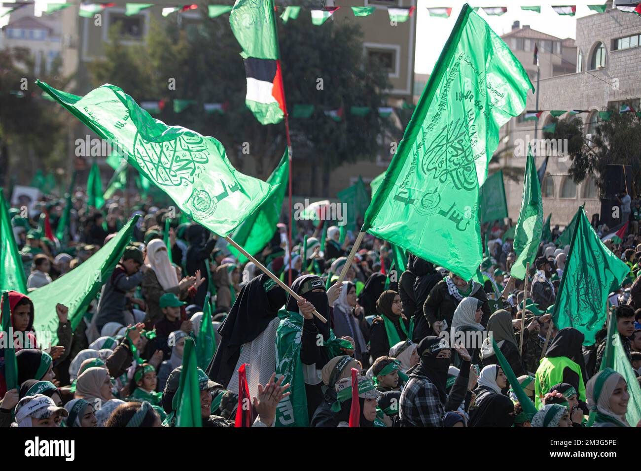 Supporters of the Palestinian movement Hamas wave their green flags ...
