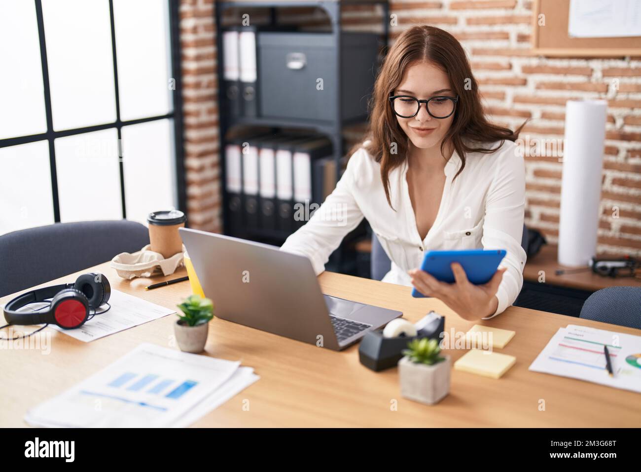 Young woman business worker using laptop and touchpad at office Stock ...