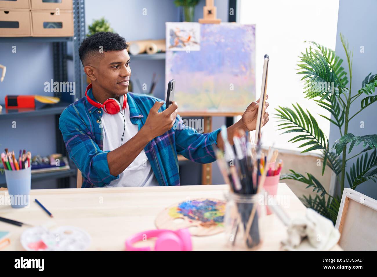 Young latin man artist make photo to draw at art studio Stock Photo - Alamy