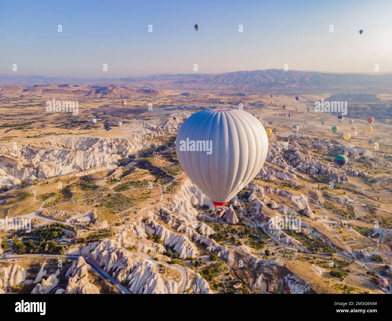 Colorful hot air balloons flying over at fairy chimneys valley in ...