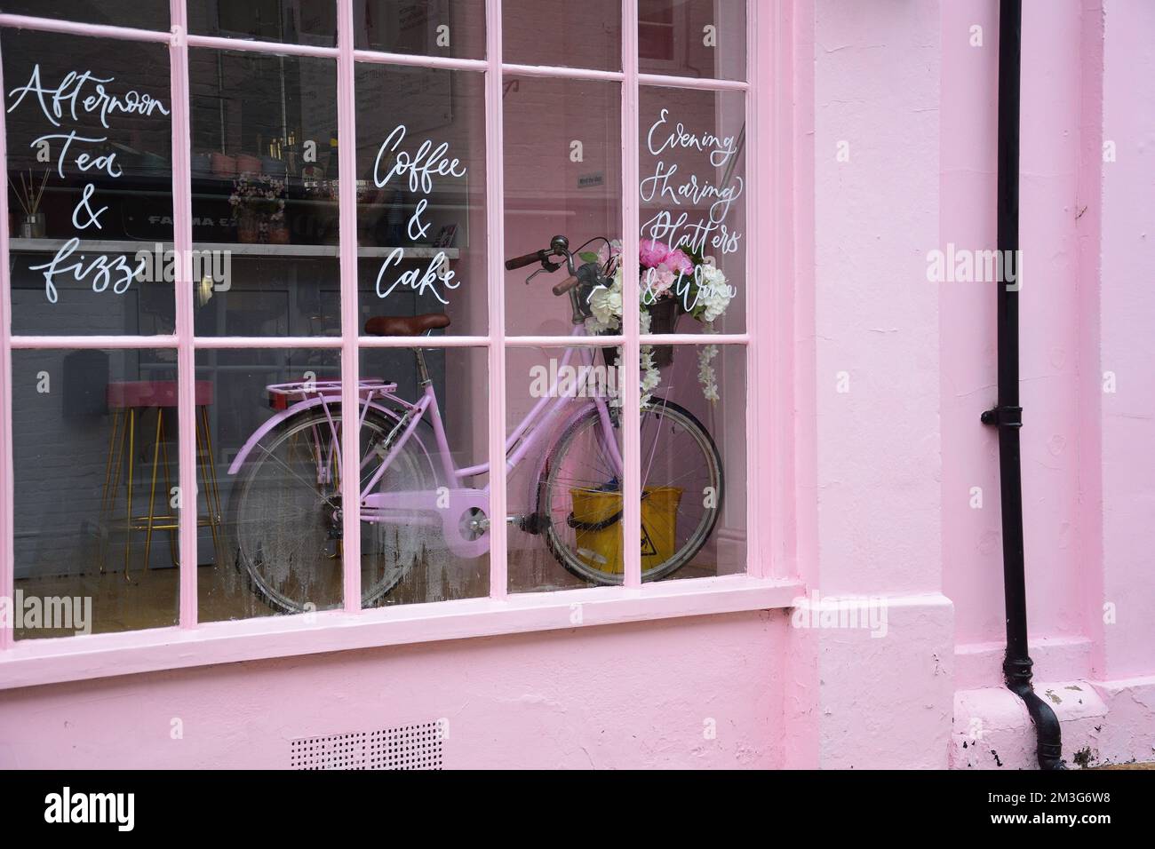 Pink shopfront with bicycle in Winchester Stock Photo - Alamy