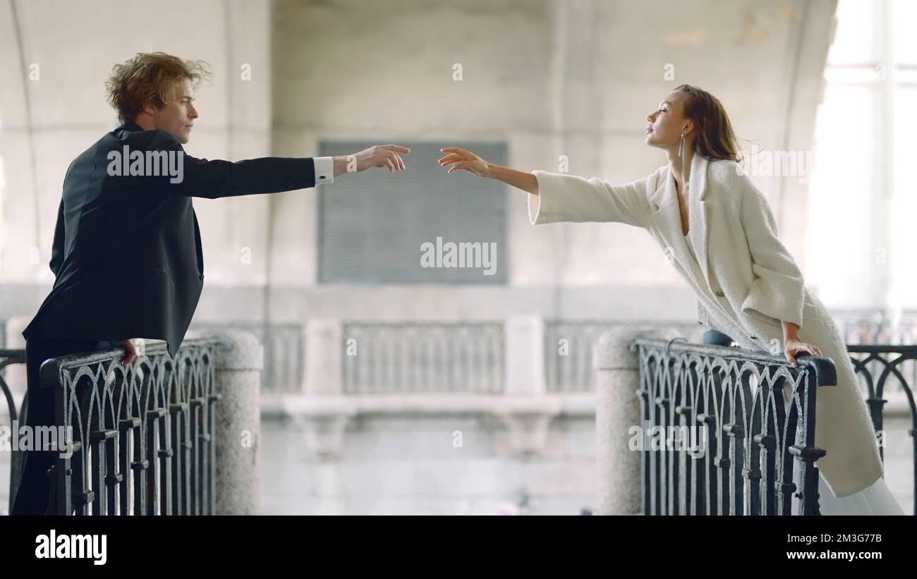 Couple reaches out to each other. Action. Romantic couple reach out ...