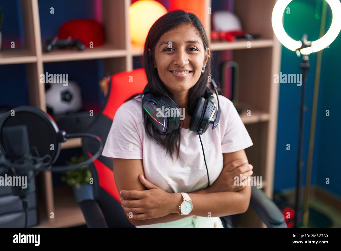 Young beautiful hispanic woman streamer smiling confident sitting with ...