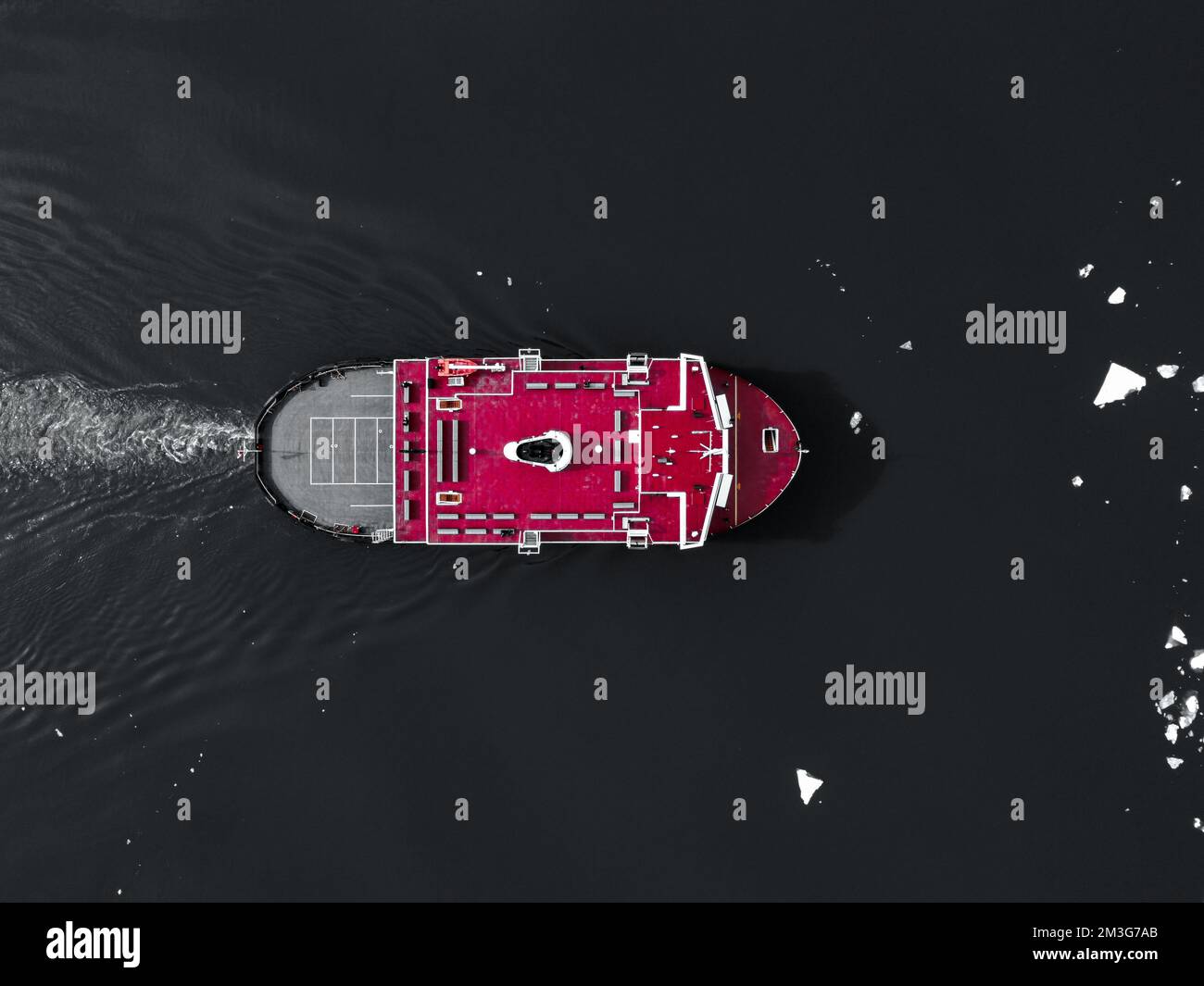 An aerial view over a red ship under the sunlight in a sea Stock Photo ...