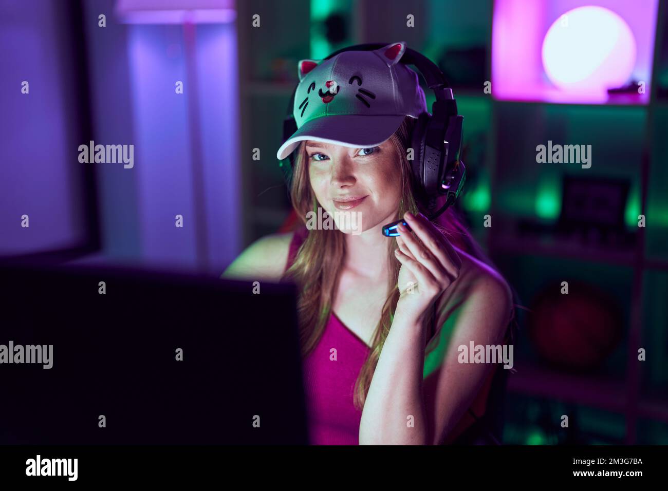 Young woman streamer using computer and headphones at gaming room Stock ...