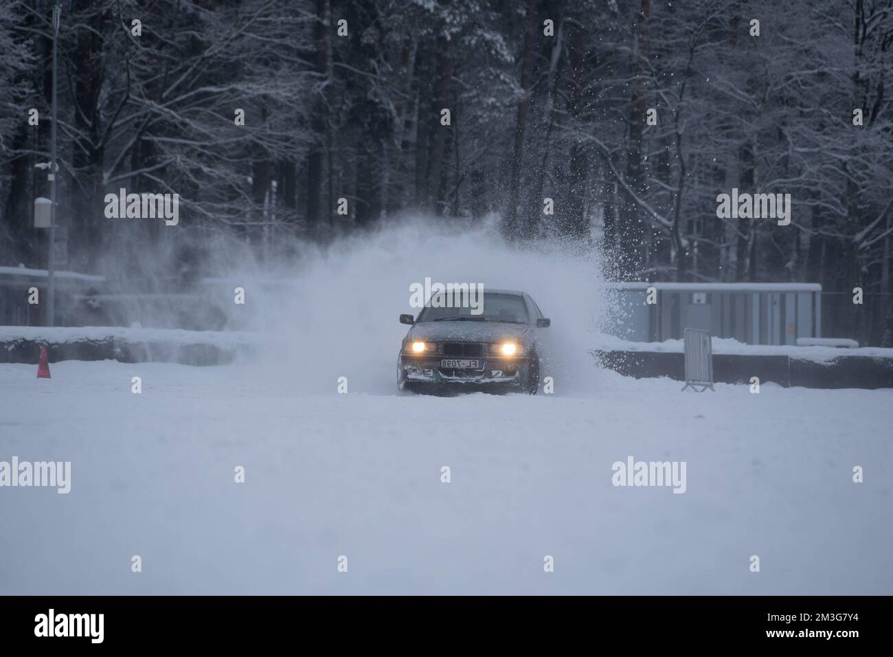 12-12-2022 Riga, Latvia a car driving through a snow covered forest in ...