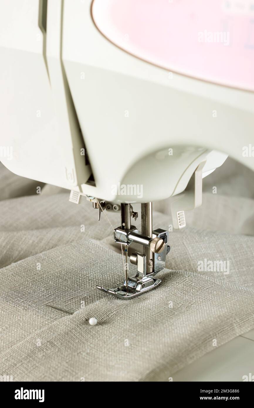 The modern sewing machine and item of clothing. sewing process Stock ...