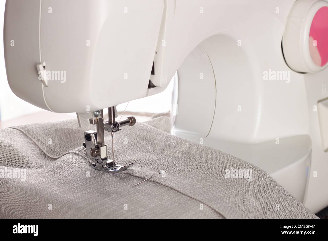 The modern sewing machine and item of clothing. sewing process Stock ...