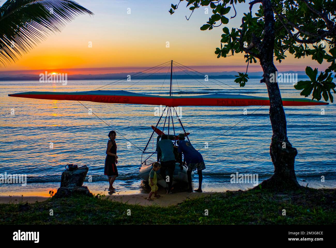 Flying Ultra light plane on a zodiac at sunset, Island Ile Sainte Marie ...