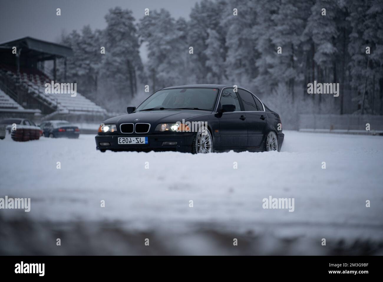 12-12-2022 Riga, Latvia a black car parked in a parking lot covered in ...