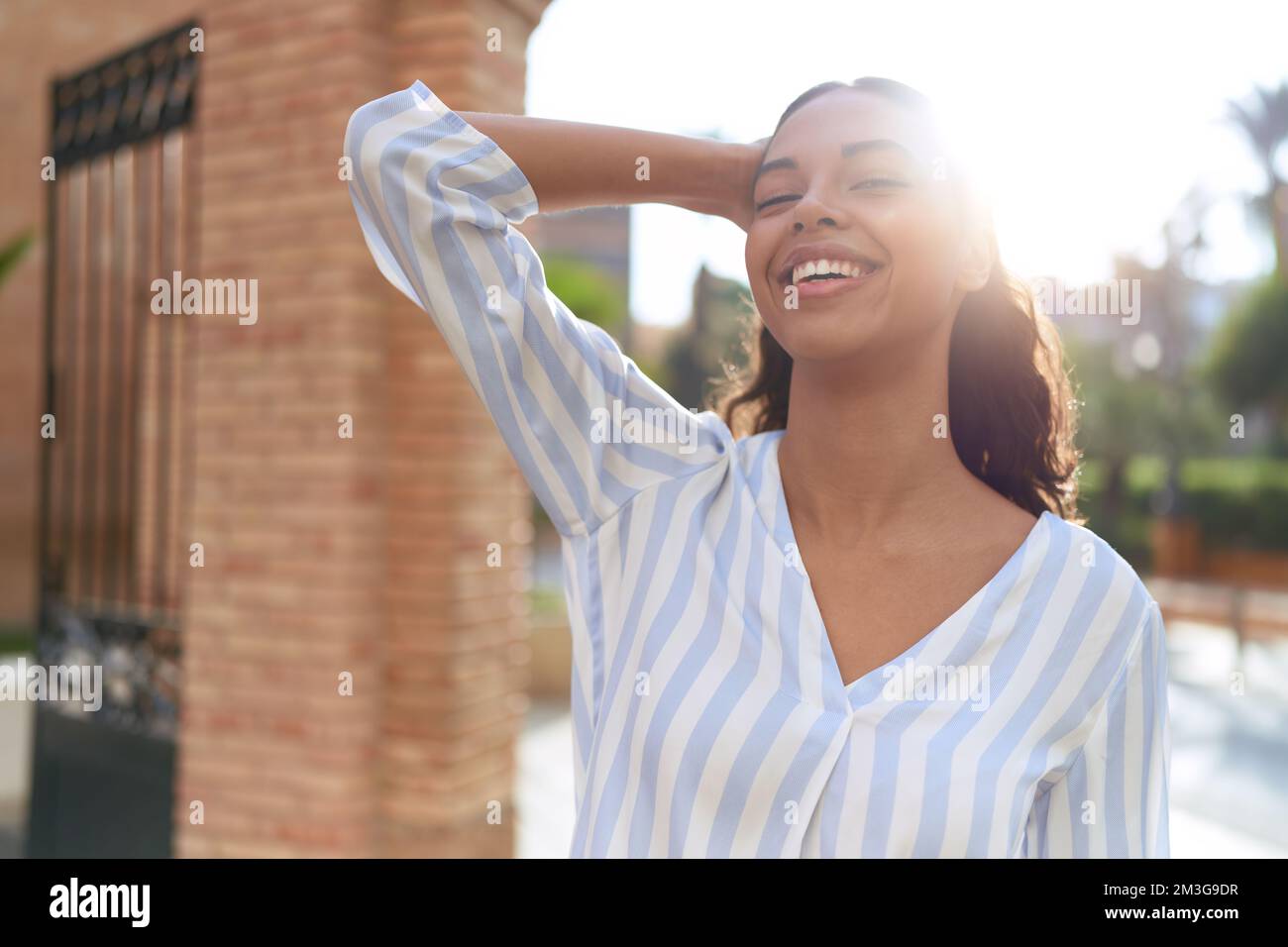 Young african american woman smiling confident relaxed with hand on ...