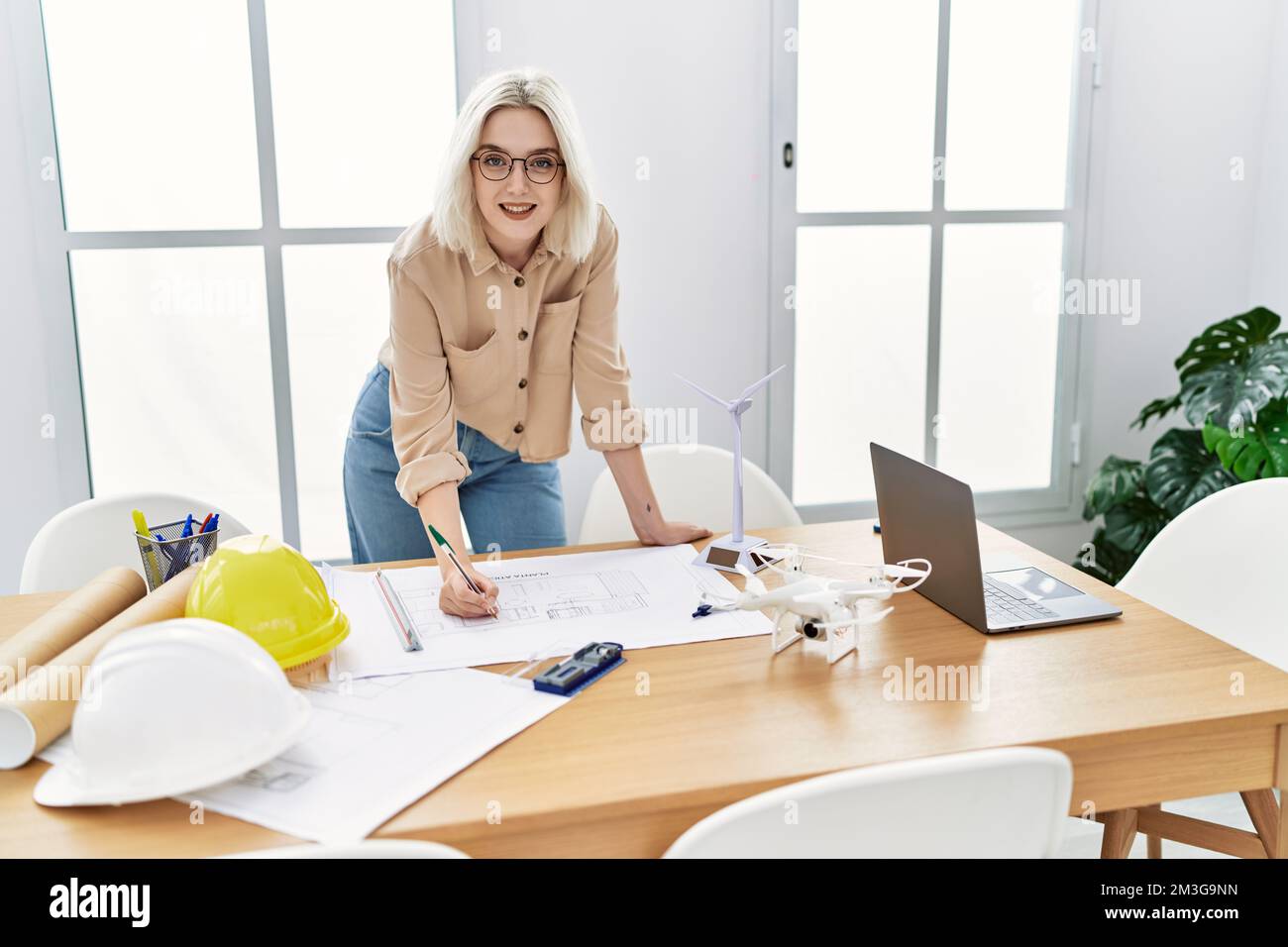 Young caucasian woman smiling confident working at architect studio ...