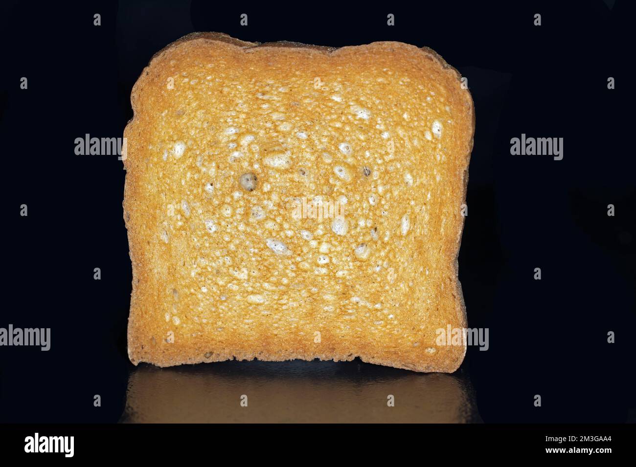 A slice of rusk, bread-like pastry, food photography with black ...