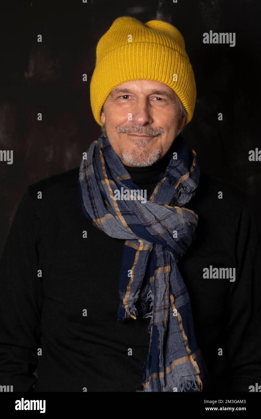Older man with yellow winter cap smiles Stock Photo - Alamy