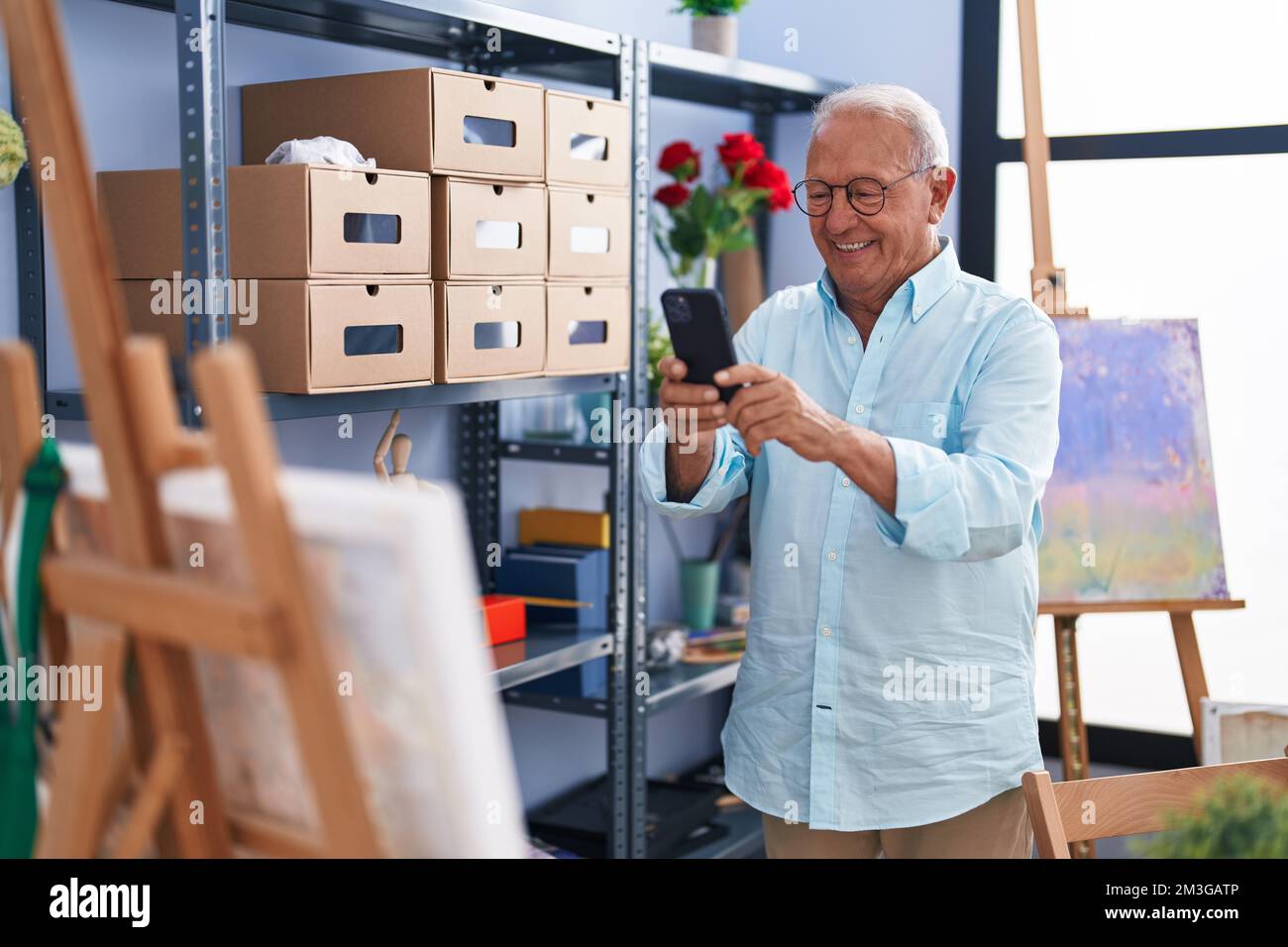 Senior grey-haired man artist smiling confident make photo by ...