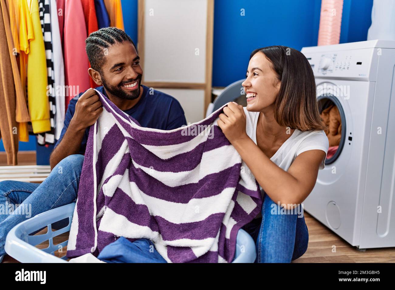 Man and woman couple smelling towel washing clothes at laundry Stock Photo - Alamy