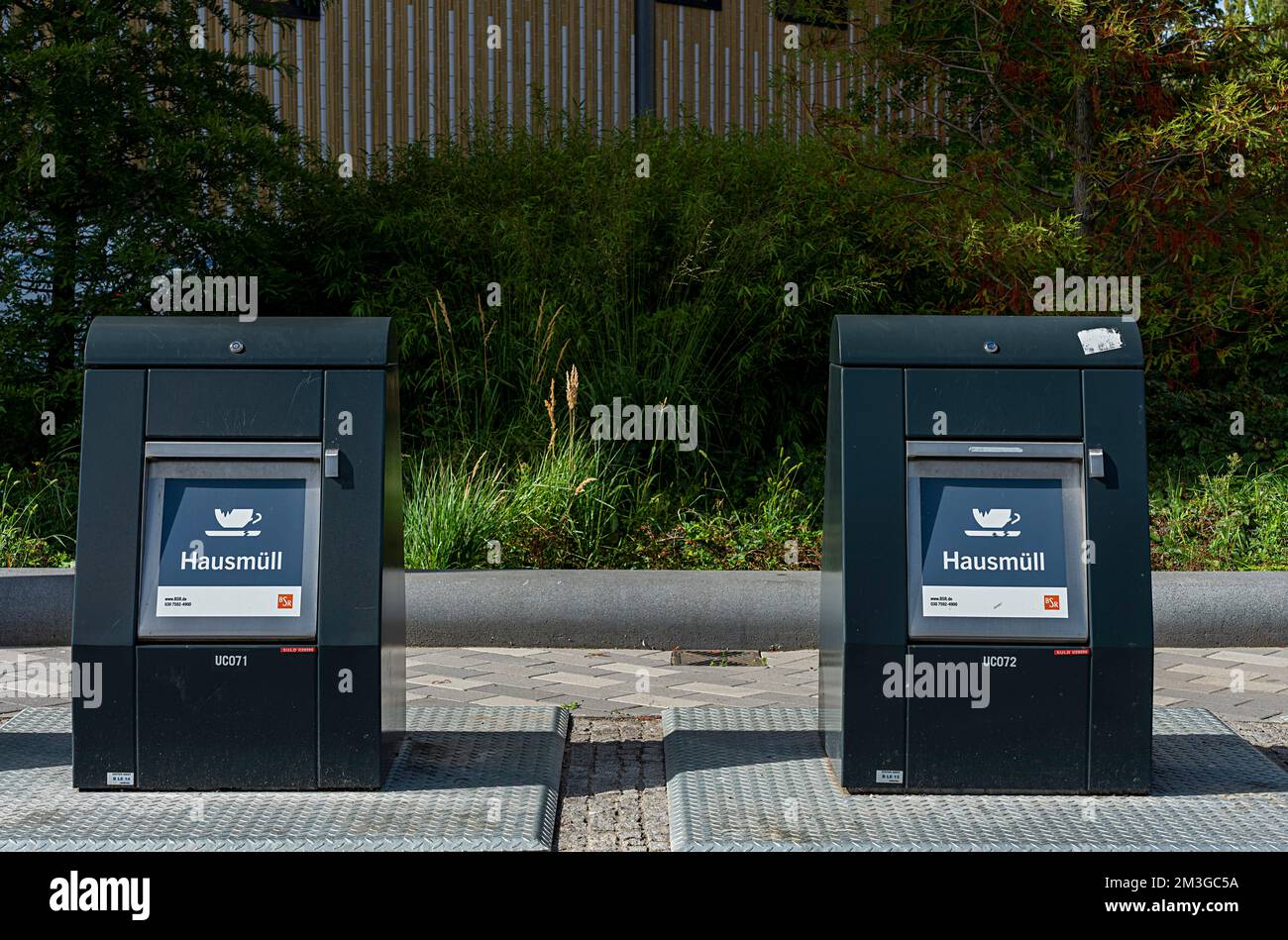 Modern household waste containers in front of new buildings in ...