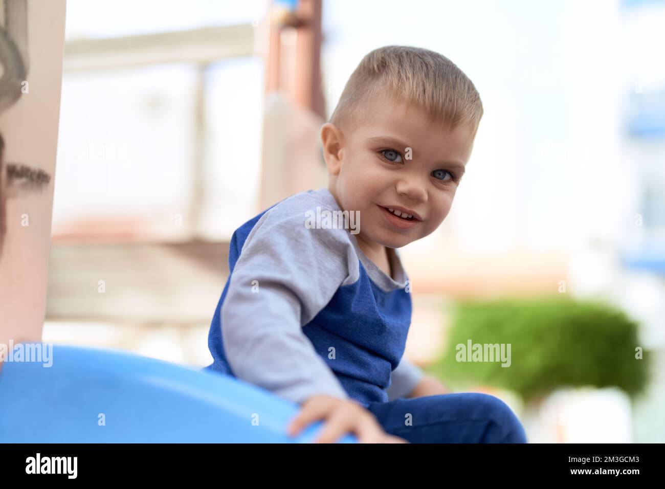 Adorable toddler smiling confident playing on slide at park playground Stock Photo - Alamy
