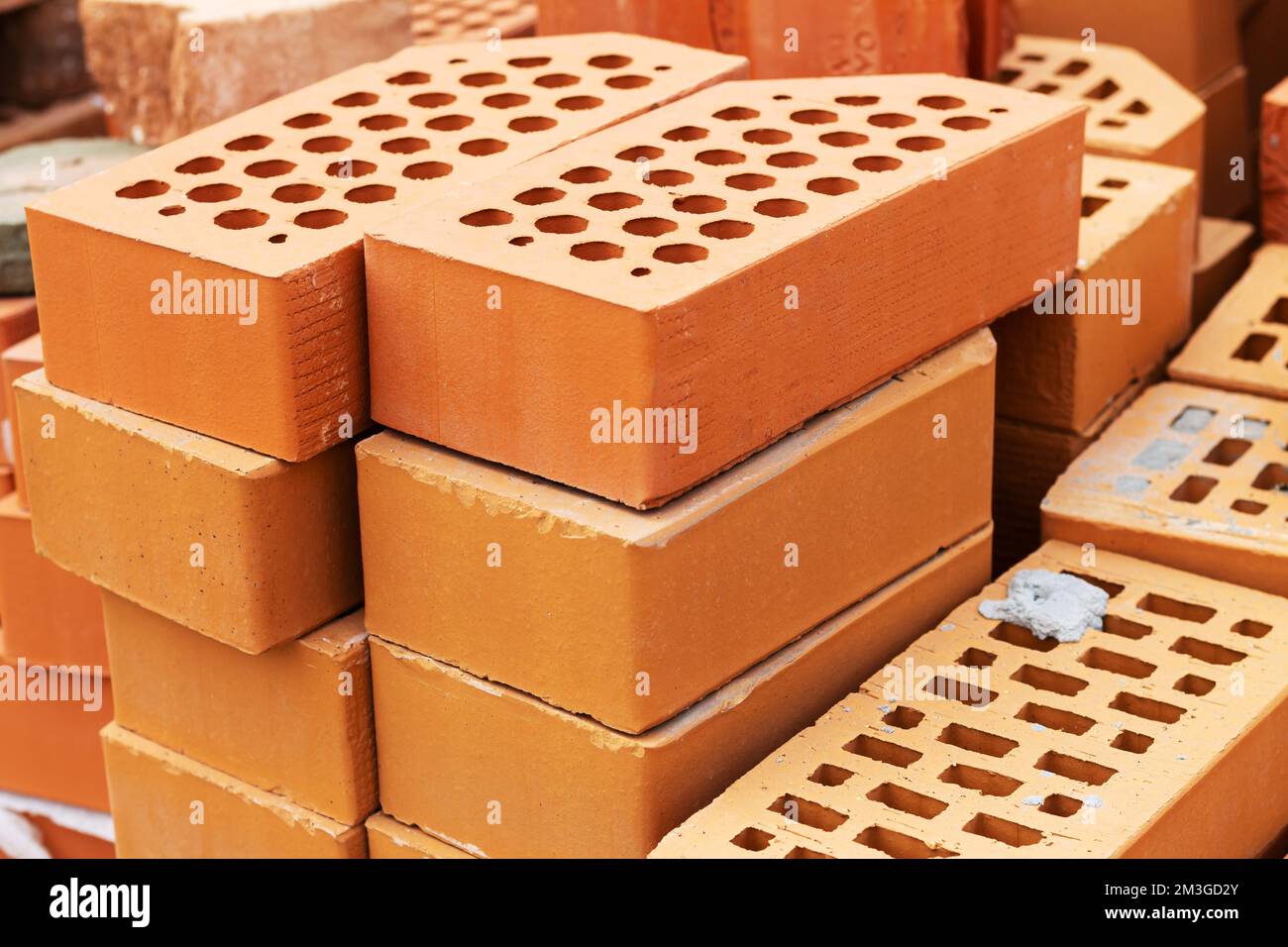 Heap of new red clay bricks for building construction Stock Photo - Alamy