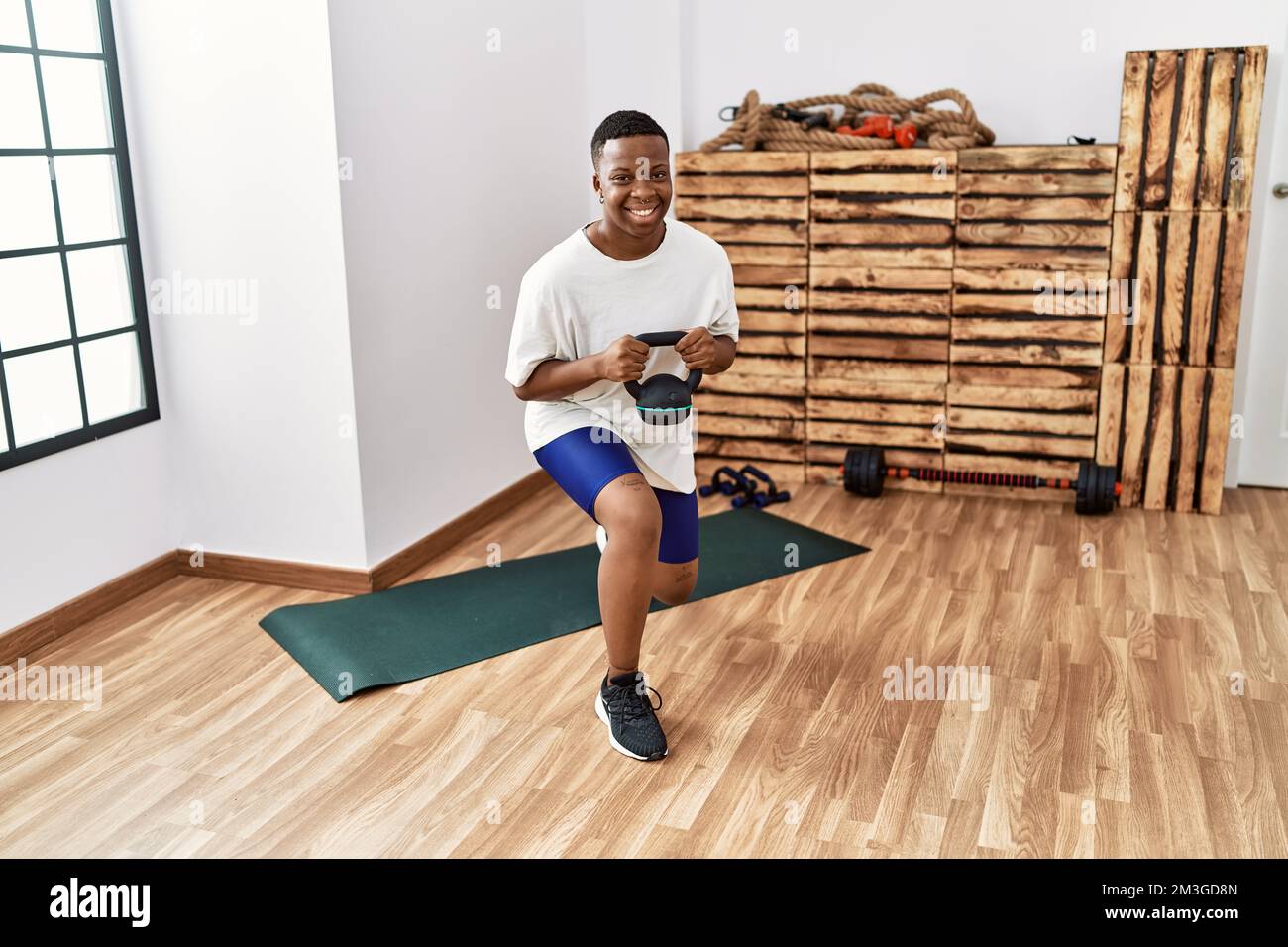 Young african man training with dumbbells at the gym Stock Photo - Alamy