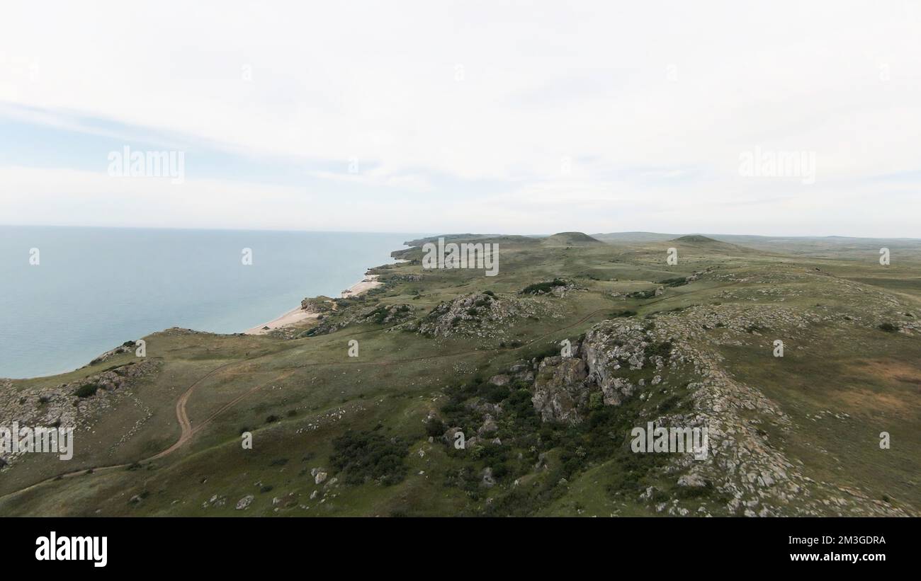 Top view of hilly coast on background of sea horizon. Shot. Coast line ...