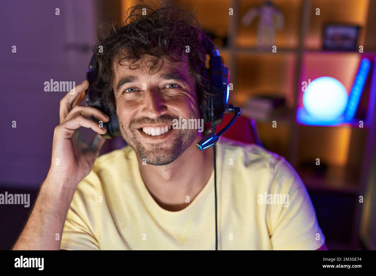Young hispanic man streamer smiling confident sitting on table at ...