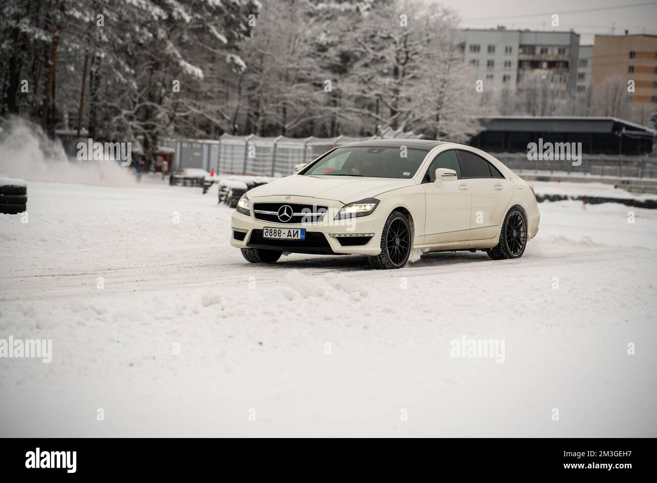 12-12-2022 Riga, Latvia a white car parked on a snowy road in the snow ...