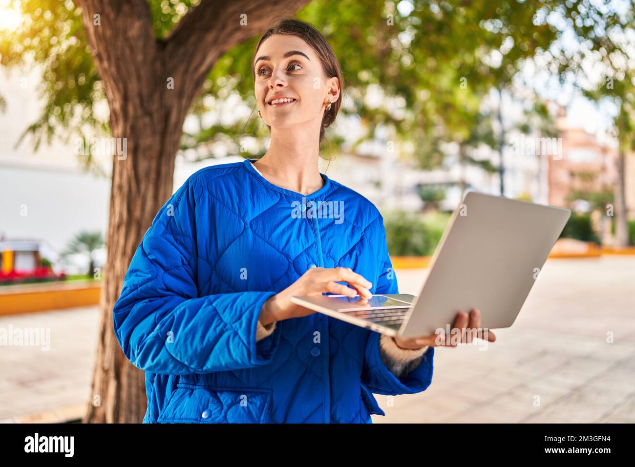 Young caucasian woman smiling confident using laptop at park Stock ...