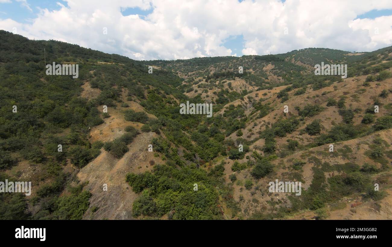 Top view of mountain climb with green trees. Shot. Hilly green ...