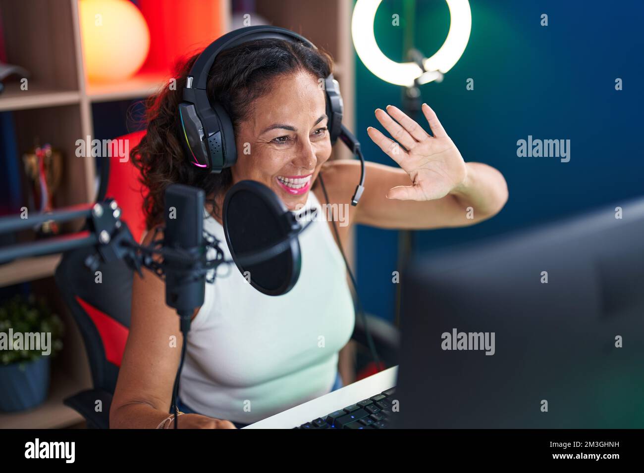 Middle age woman streamer smiling confident having video call at gaming ...